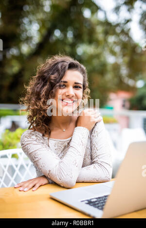 Freelancer woman in a summer cafe doing remote work Stock Photo - Alamy