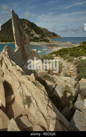 A vertical shot of a pool on the shore of a beach with the sea in the ...