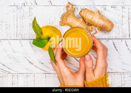 Womans hands holding turmeric drink Stock Photo - Alamy