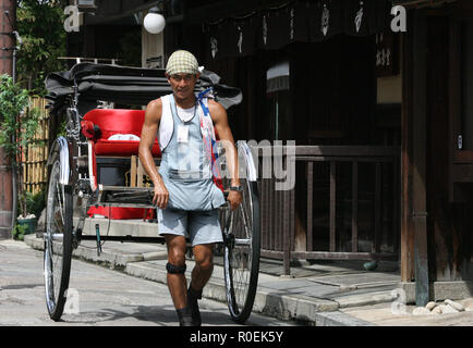 A pulled rickshaw, a mode of human-powered transport by which a runner ...