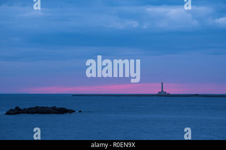Lighthouse photographed against the sunset with pink sky, in Gallipoli ...