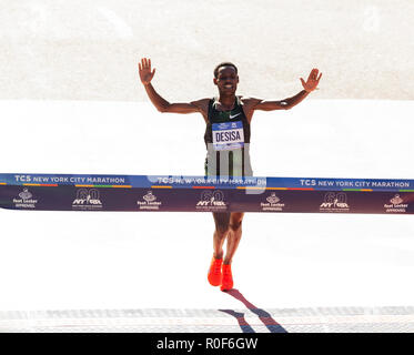 Lelisa Desisa of Ethiopia crosses the finish line in third place in the ...