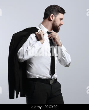 Portrait of a businessman holding jacket over his shoulder isolated on ...