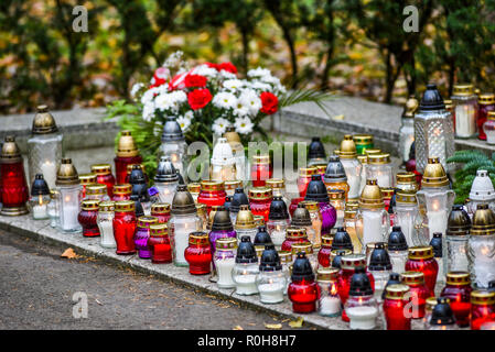 Flowers and candles on a colorful polish cemetery. Autumn, preparations ...