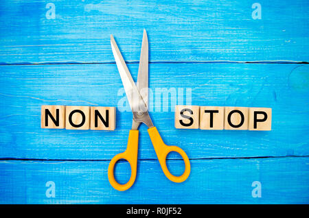 concept of motivation. the inscription "non stop" and scissors between ...
