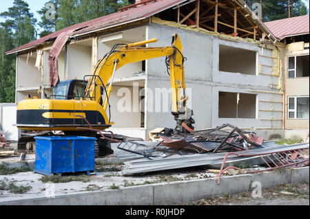 Scrap metal in front of partially demolished house Stock Photo - Alamy
