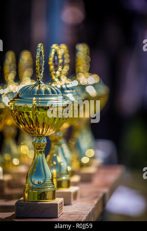 Group of trophies lined up on the shelf Stock Photo - Alamy