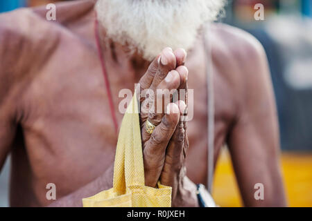 Old Indian man greeting with his palms together in a namaste gesture ...