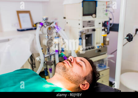 Young man lies on the operating table at the clinic Stock Photo - Alamy