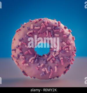 Single round donut on blue background Stock Photo - Alamy