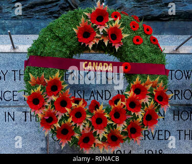 Canadian poppy for remembrance day with Canada flag pin on dark ...