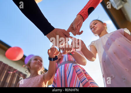 Children smile and put up their hand eagerly to answer a question in ...