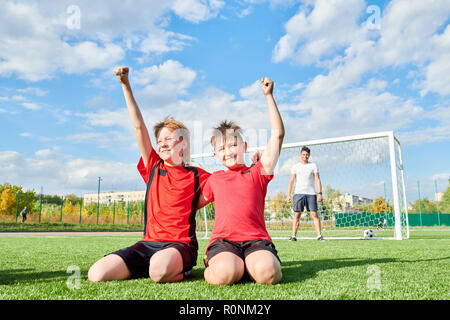 happy football players with soccer ball on field of big stadium Stock ...