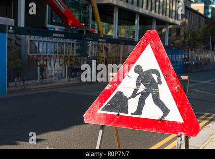 Men at work street sign with building site to the rear. Cambridge ...