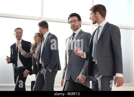 students with a teacher move forward in the foyer Stock Photo - Alamy