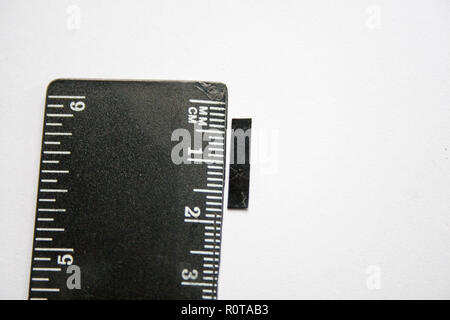 measuring a strip of black material Stock Photo - Alamy