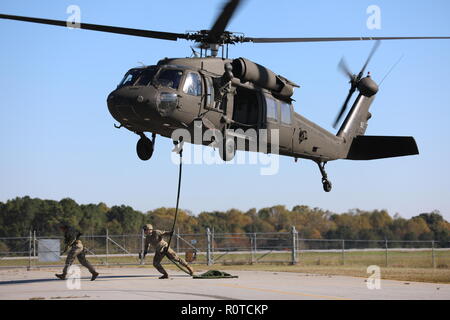 U.S. Army Ranger soldiers fast rope from a USA UH-60 Black Hawk ...