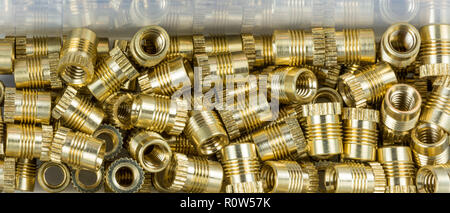 Bronze threaded inserts as background. Close-up of decorative pile from ...
