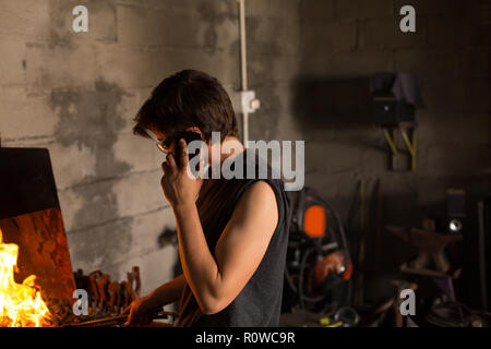 Female blacksmith working in workshop Stock Photo - Alamy