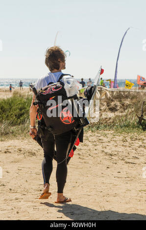 Kitesurfer carrying heavy gear at mediterranean sea kitesurfing ...