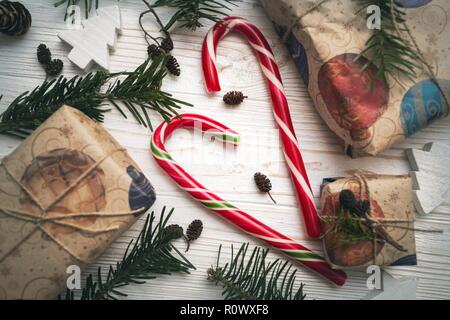 Christmas backgrounds. Gifts and candy caner on the wooden background ...