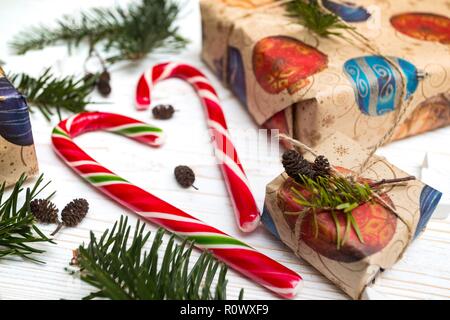 Christmas backgrounds. Gifts and candy caner on the wooden background ...