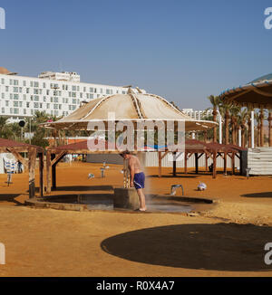 Man is washed in the shower on the beach of Dead sea, Israel Stock ...