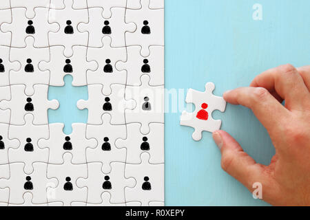 image of puzzle with people icons over wooden table ,human resources ...