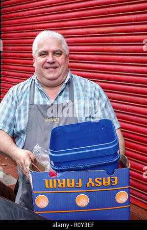 Smiling man taking out garbage Stock Photo - Alamy