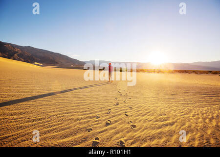 Hiker among sand dunes in the desert Stock Photo - Alamy