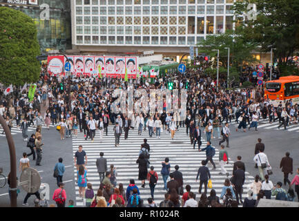 People walk through Shibuya Crossing in Tokyo, Japan Stock Photo - Alamy