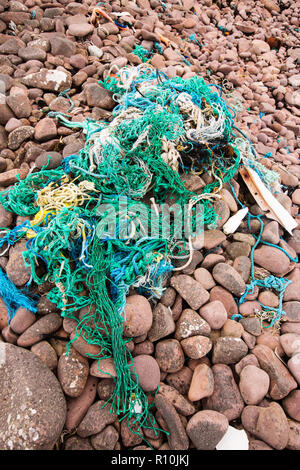 Fishing netting and other plastics in the tide wrack, washed ashore on ...