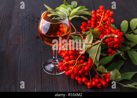 Handmade rowan-vodka and red berries of rowan tree Stock Photo - Alamy