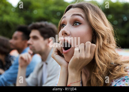 Image of emotional shocked group of friends standing isolated over grey ...