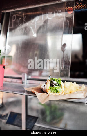 Food served through window of food truck Stock Photo - Alamy