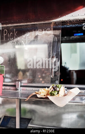 Food served through window of food truck Stock Photo - Alamy