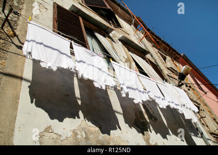 Washing hanging on lines between buildings Stock Photo - Alamy