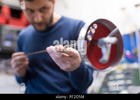 Fencing prop maker at work Stock Photo - Alamy