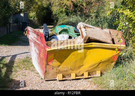 Skip full of building rubble Stock Photo - Alamy
