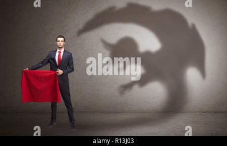 Businessman standing with red cloth on his hand and his shadow on the ...