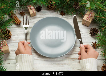 Female hand holds ceramic Christmas ball hanging on ribbon. Christmas ...