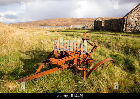 An old rusting farm implement at Balchrick, Sutherland, Scotland, UK ...