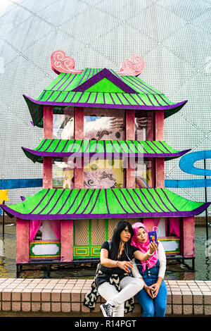Tourists take a selfie in front of giant ice sculptures during the 32nd ...