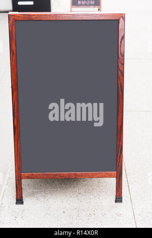 Blank chalk board stand mockup with colorful fall leaf close up on ...