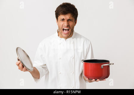 Image of screaming angry young chef man standing isolated over white ...