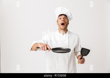 Male chef with an empty plate and a frying pan Stock Photo - Alamy
