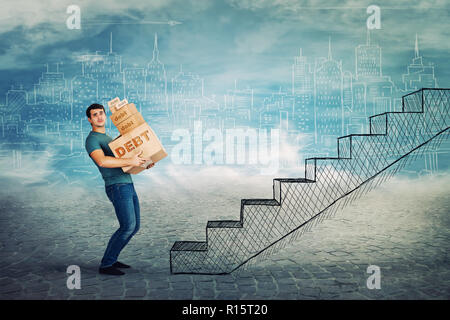 Frustrated young man lean back carrying a heavy box isolated on white ...