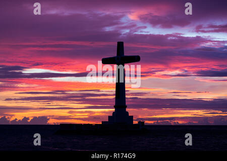 Catholic cross in sunken cemetery in the sea at sunset, aerial view ...