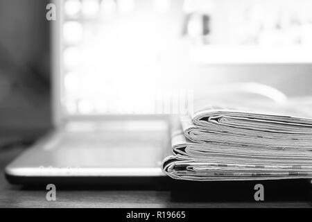 Stack of newspapers and laptop. Journals with news and computer. Papers ...
