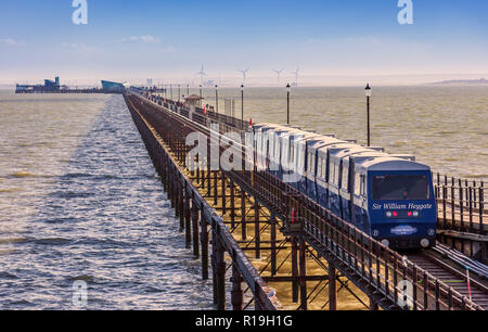 Southend on Sea, Essex. A train goes along the mile-long pier at low ...